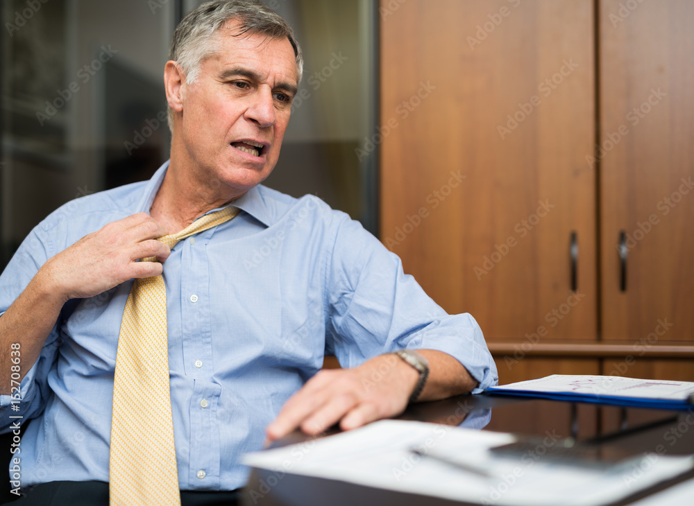 Businessman sweating in his office Stock Photo | Adobe Stock