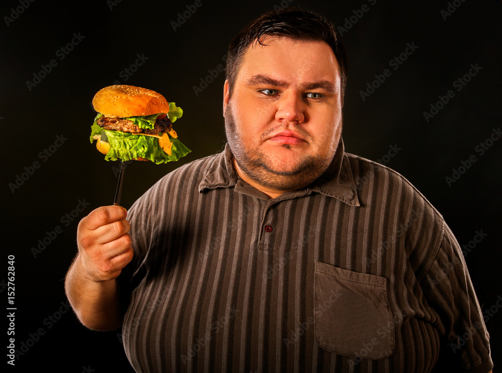 Diet failure of fat man eating fast food hamberger. Happy smile ...