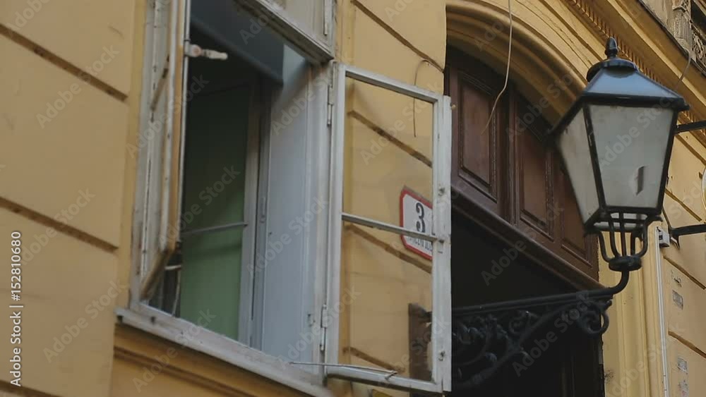 View on open window of old building and streetlight, hospitality and ...