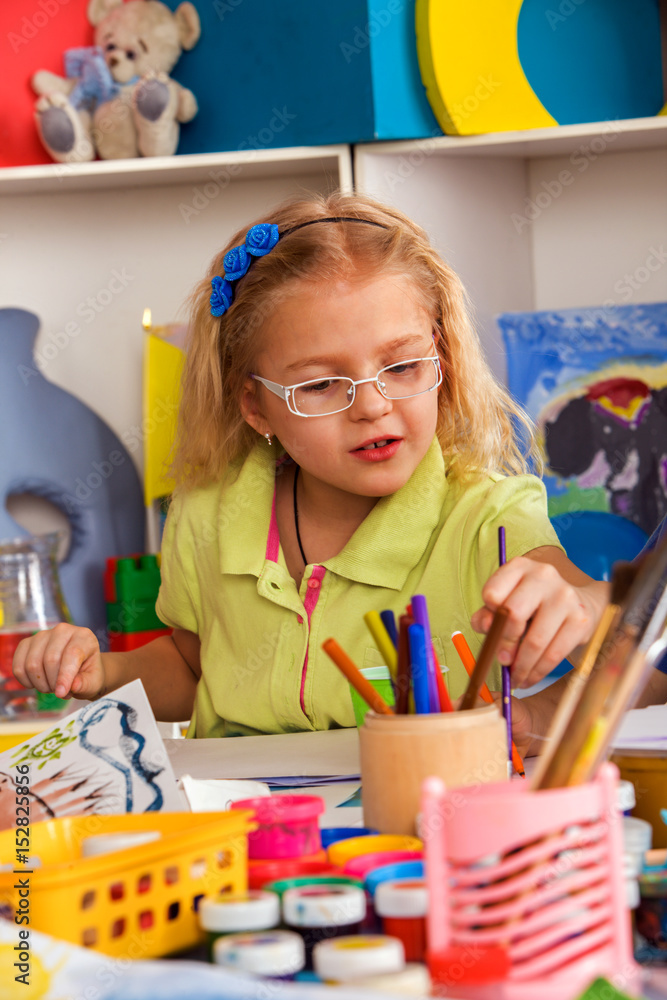 Small student girl painting in art school class. Child drawing by ...