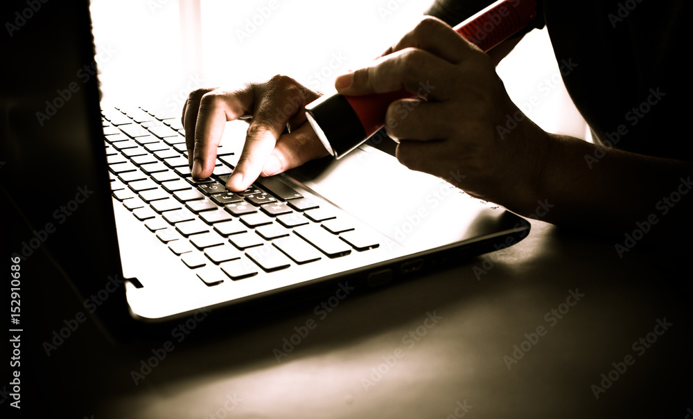 anonymous hacker typing on keyboard of laptop for remotely hacking and ...