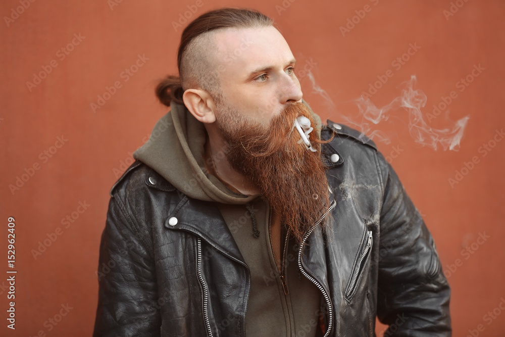 Bearded man smoking weed outdoors on color background Stock-Foto ...