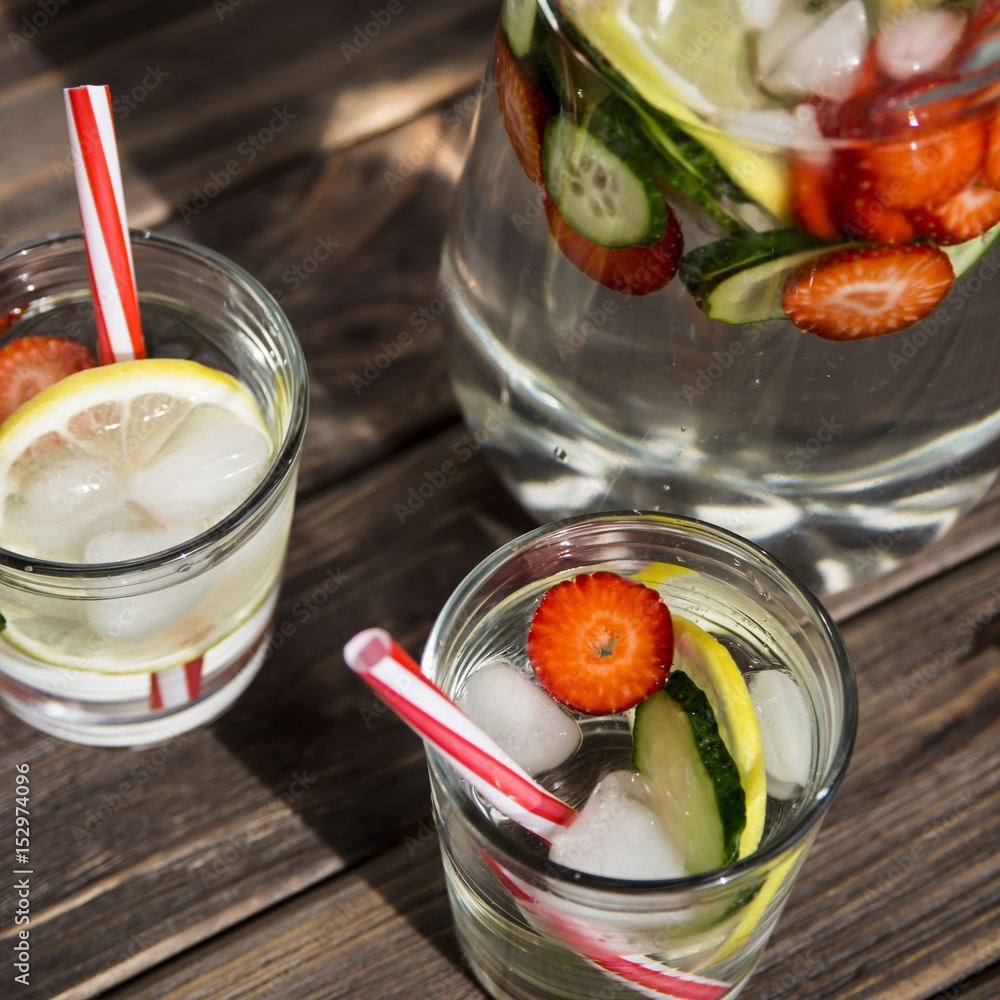 Water with lemon strawberries and cucumber Stock Photo | Adobe Stock