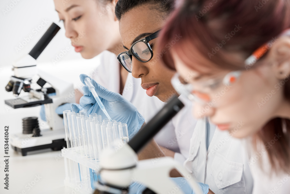 Multiethnic group of young professional scientists working with ...