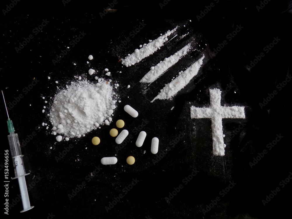 Cocaine drug powder pile, lines and cross, pills and injection syringe ...