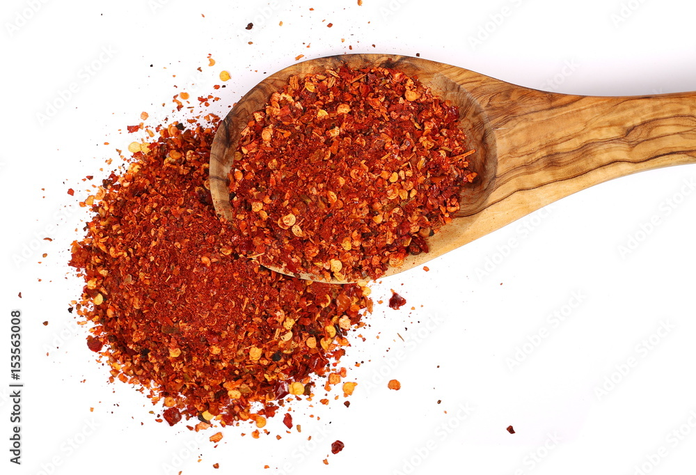 pile crushed red cayenne pepper, dried chili flakes, seeds and wooden ...