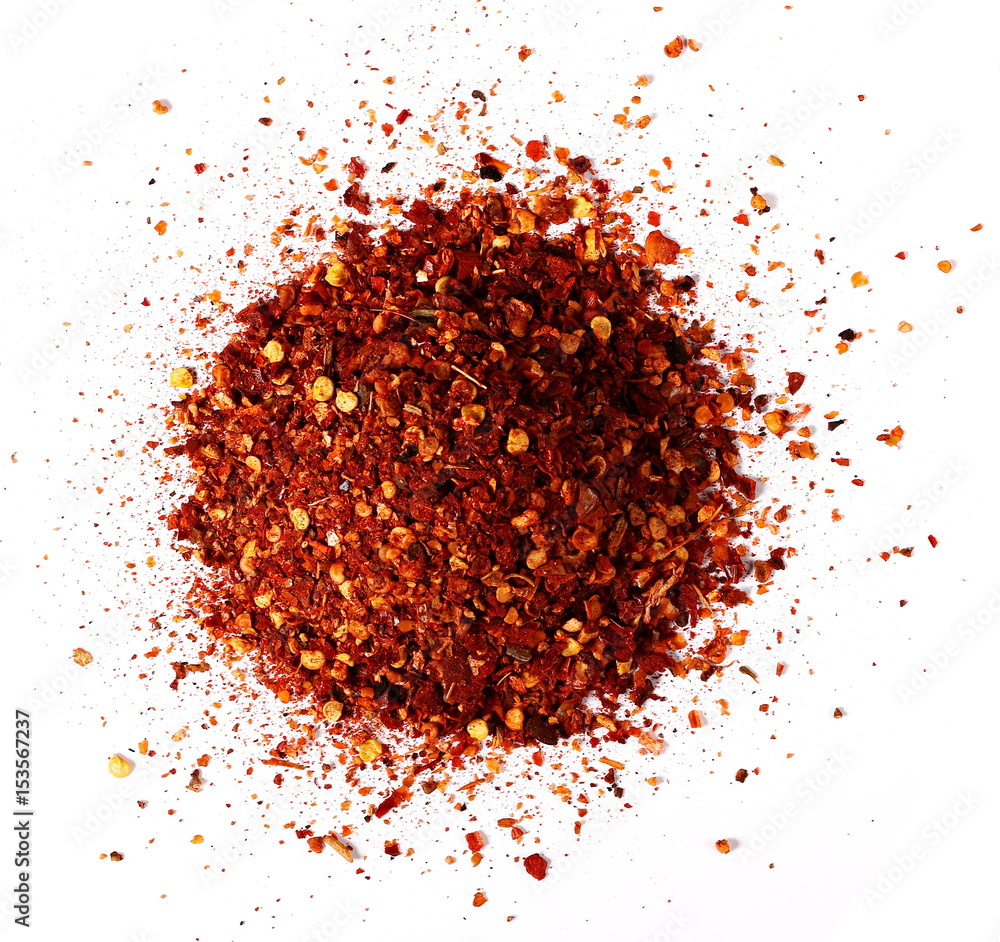 pile crushed red cayenne pepper, dried chili flakes and seeds isolated ...
