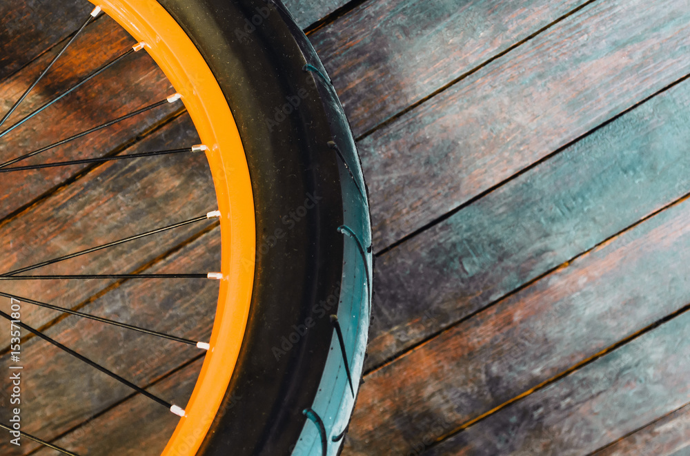 Wheel of a stylish bicycle with an orange rim and rubber tire cover ...