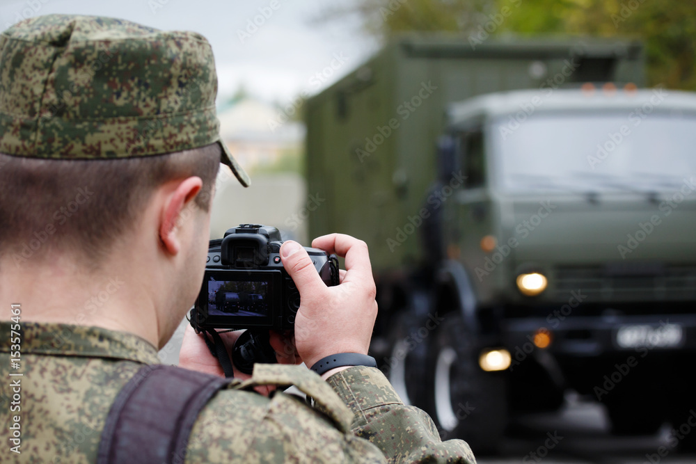 Army journalist photographer. Soldier takes picture military vehicle ...