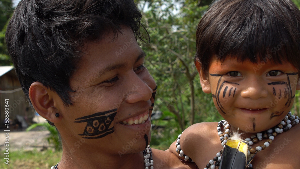 Foto de Father and Son at an indigenous tribe in the Amazon do Stock ...