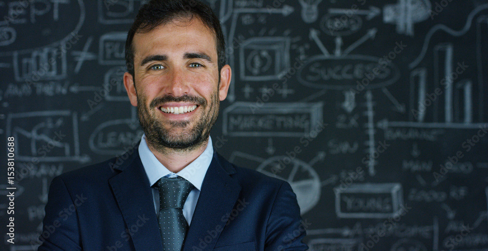 Portrait of a business man, a marketing teacher, draws a graph of ...