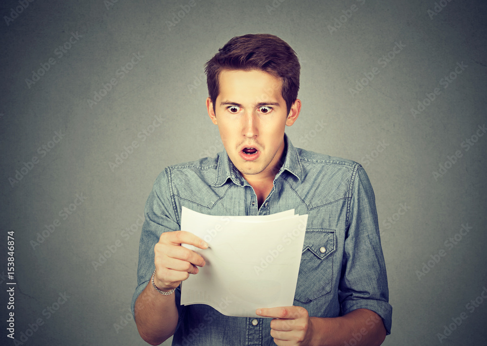Shocked man holding some documents Stock Photo | Adobe Stock
