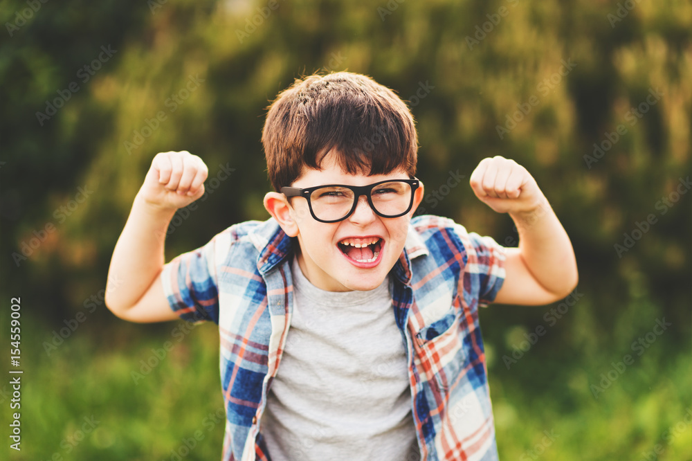 Strong and smart little boy with funny facial expression playing ...
