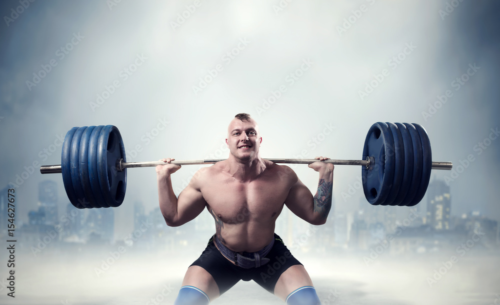 Muscular male weightlifter exercise with barbell Stock Photo | Adobe Stock