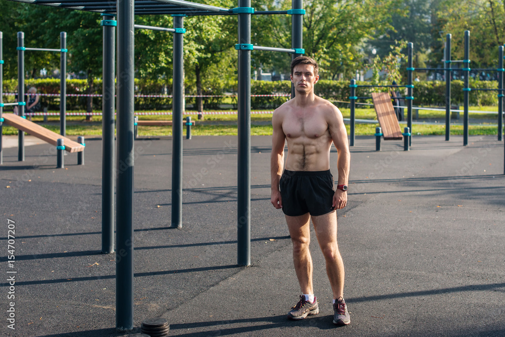 Muscular fitness male model posing shirtless demonstrating six packs ...