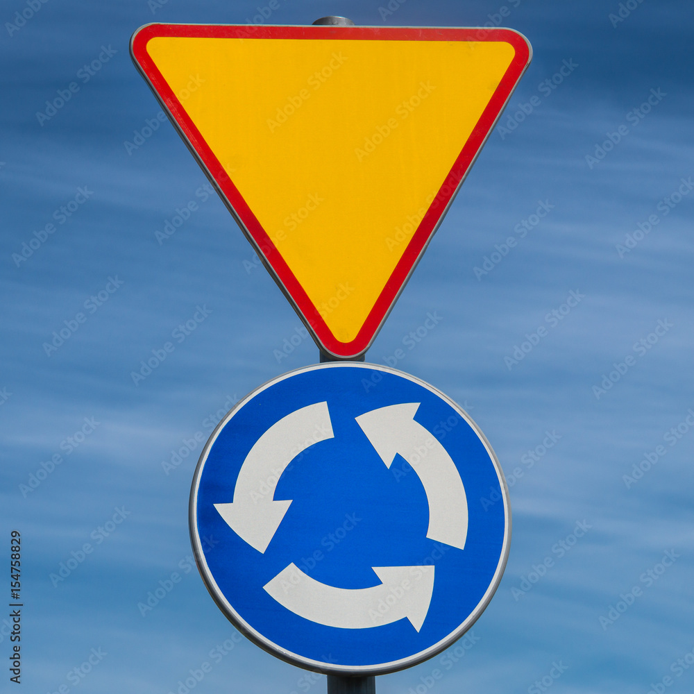 Give way and roundabout road sign. Stock Photo | Adobe Stock