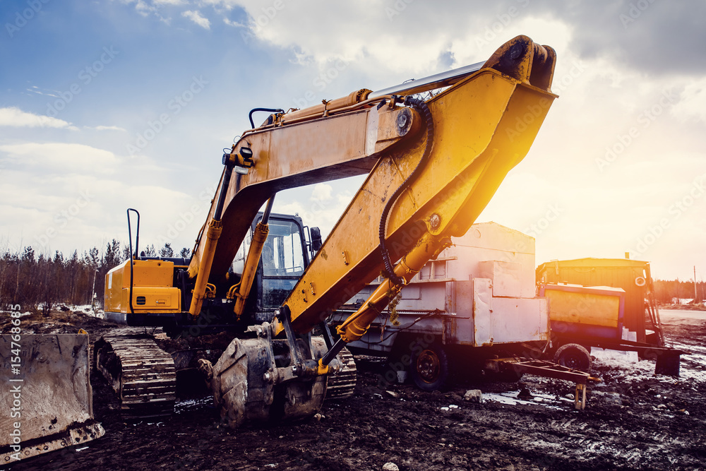 Excavators machine and bulldozer loader in construction site on sky ...