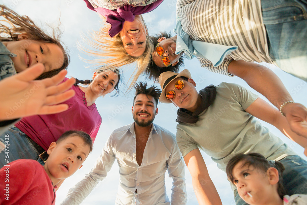 Foto de cute kids and parents with friends in a circle looking down ...