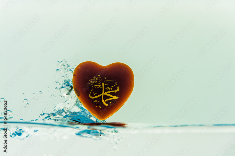 Prophet of Islam on heart shape splashing in water against white ...