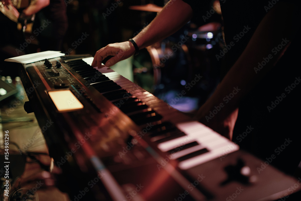 Musician playing on the keyboard synthesizer piano keys. Musician plays ...