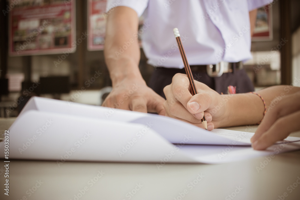 students hand write on paper, doing homework and lecture lesson ...