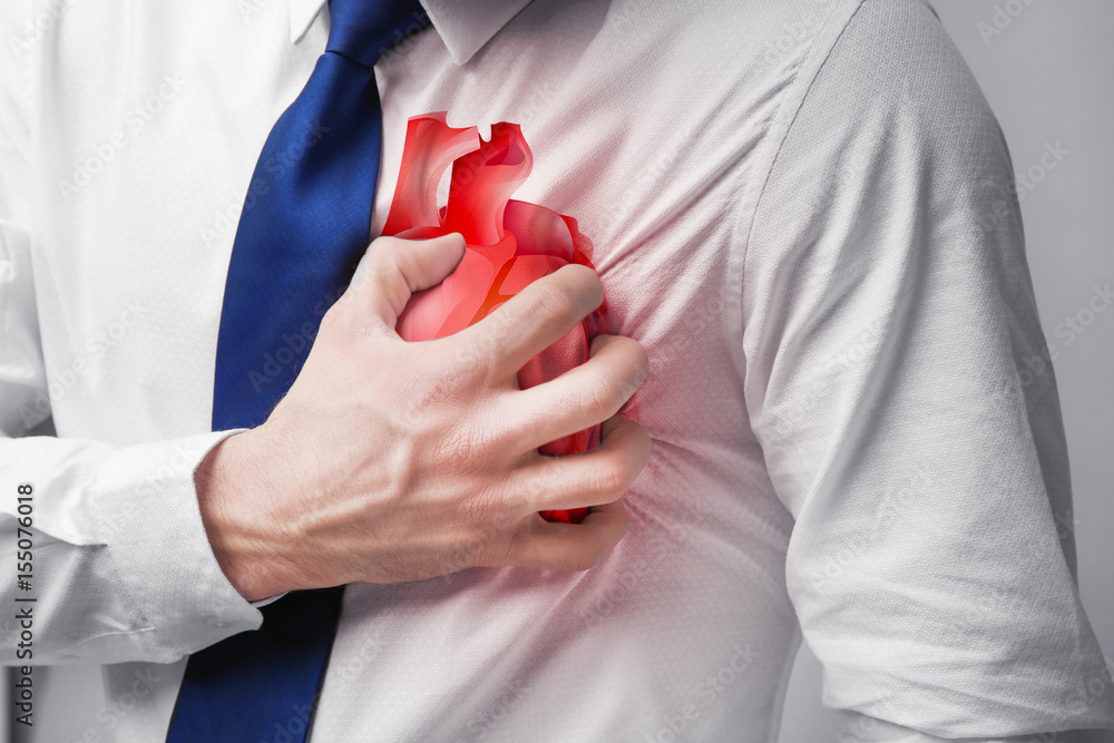 Heart attack concept. Young man suffering from chest pain, close up ...