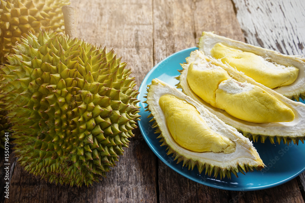 Durian King of fruit on blue plate on wooden table. Stock Photo | Adobe ...