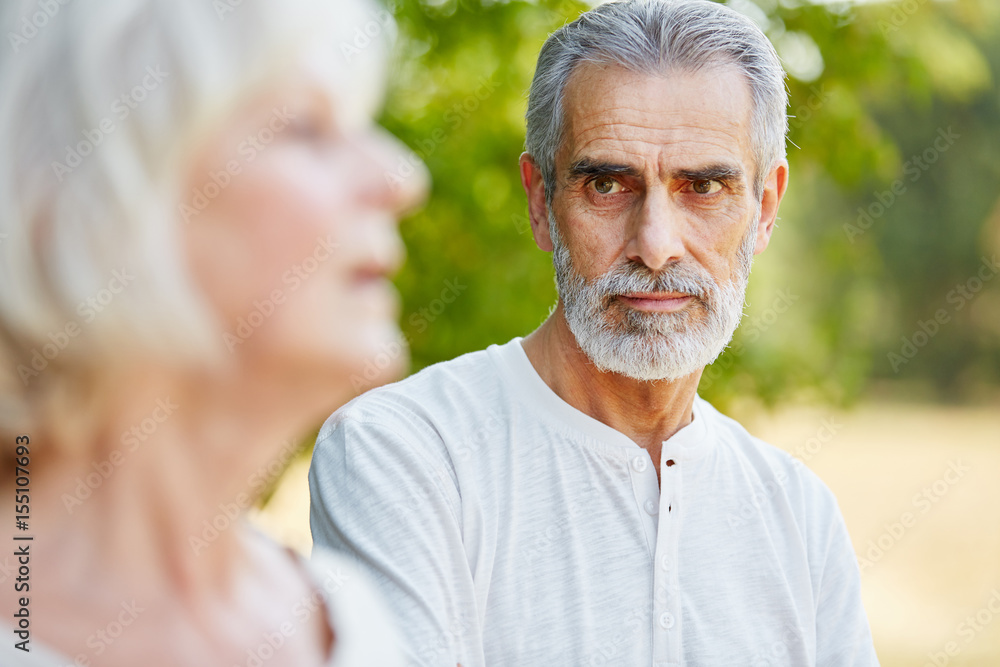 Old man staring pensive at a woman Stock Photo | Adobe Stock