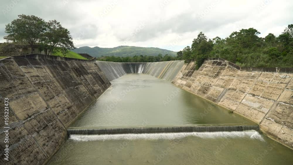 Dam on the lake in the rainforest on the island. Water flowing from the ...