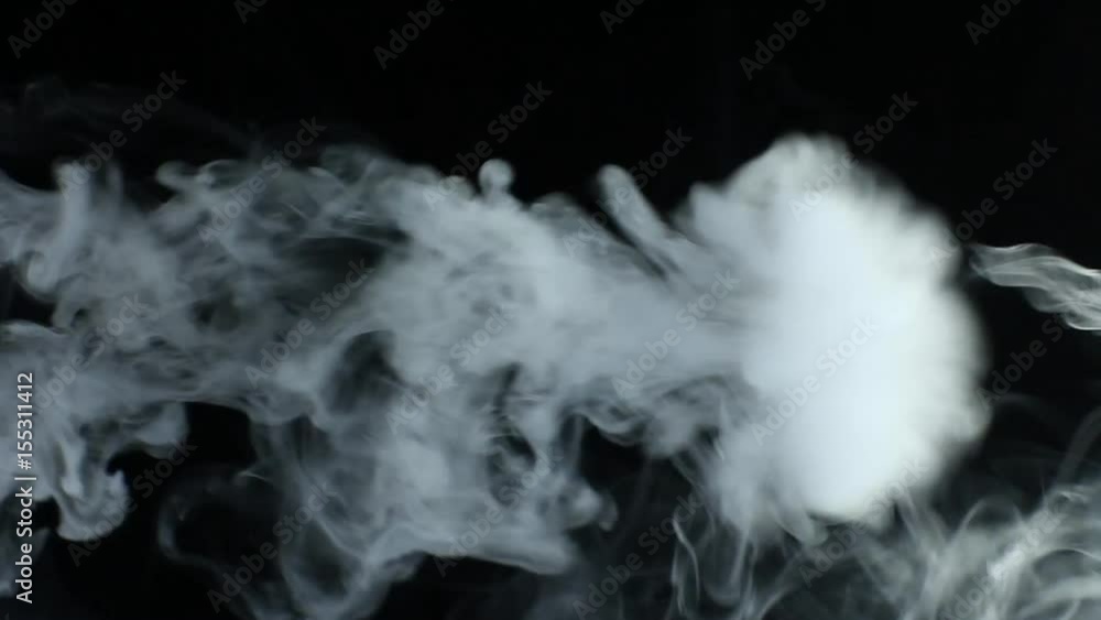 Vapor like smoke on a dark black background. Vape smoke rings in motion ...
