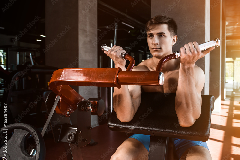 Tense muscles of hands under load. Man doing exercise for biceps in the ...
