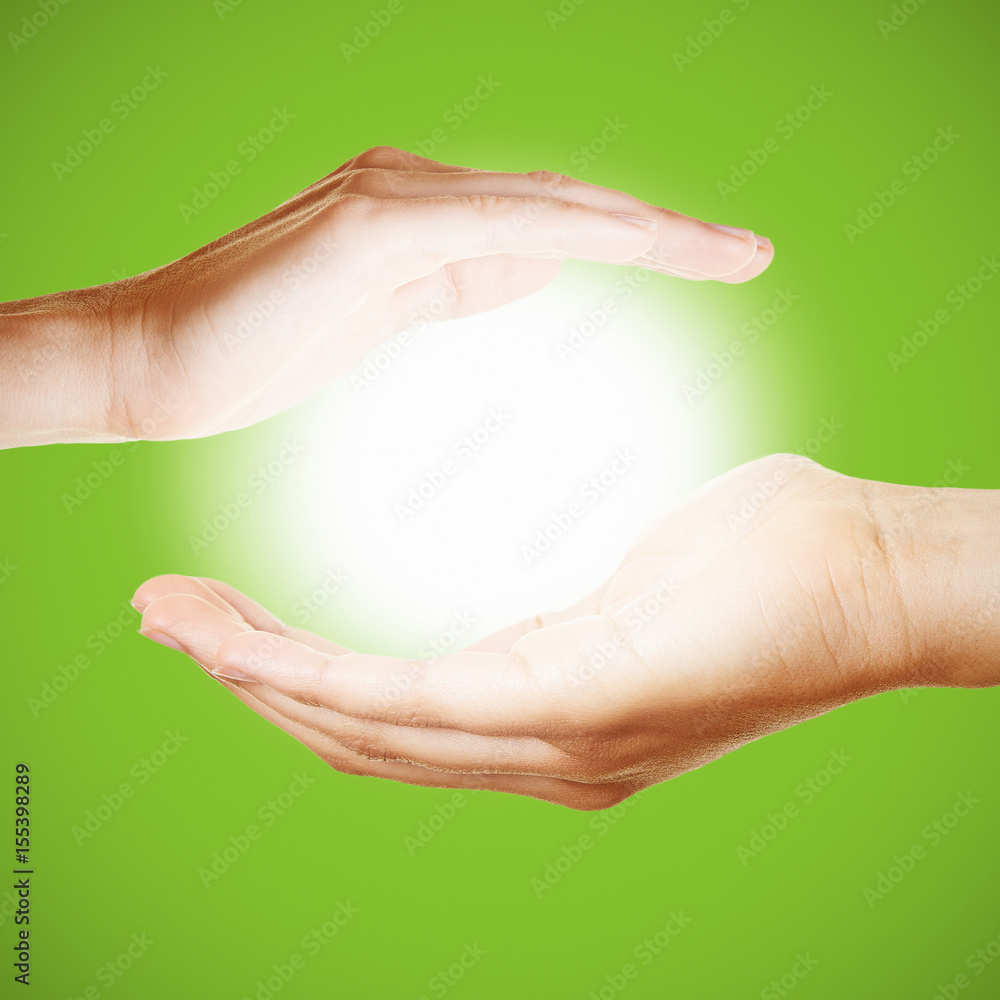Zwei Hände halten eine leuchtende Sonne Stock Photo | Adobe Stock