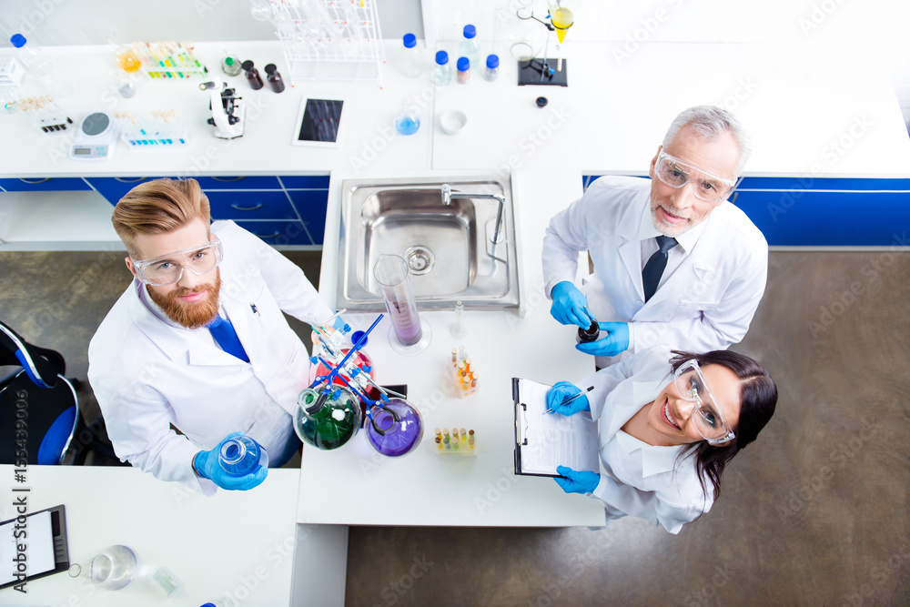Top up of lab team of three researchers working with reactants and ...