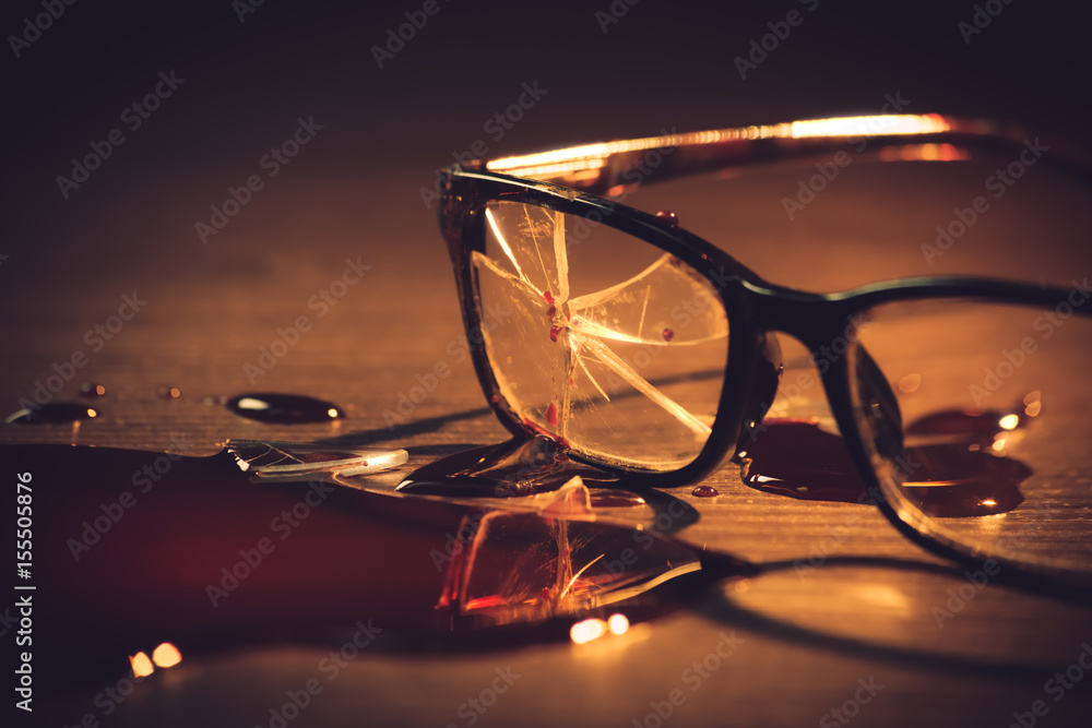 dramatic lit image of broken glasses on the floor with blood Stock ...