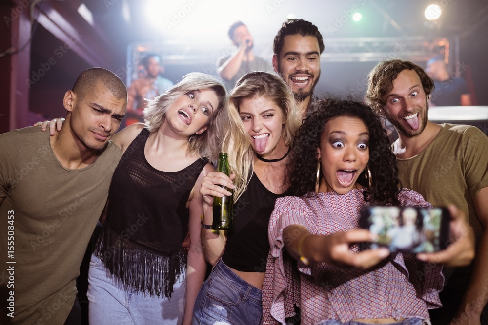 Cheerful young friends talking selfie at nightclub Stock Photo | Adobe ...