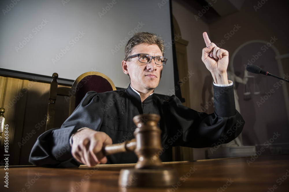 a judge with a hammer in his hand in the court room Stock Photo | Adobe ...