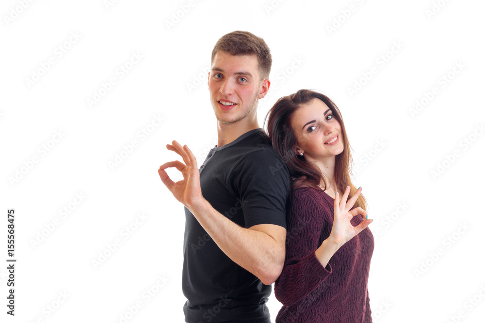 beautiful loving couple stand backs to each other smile and show hands ...