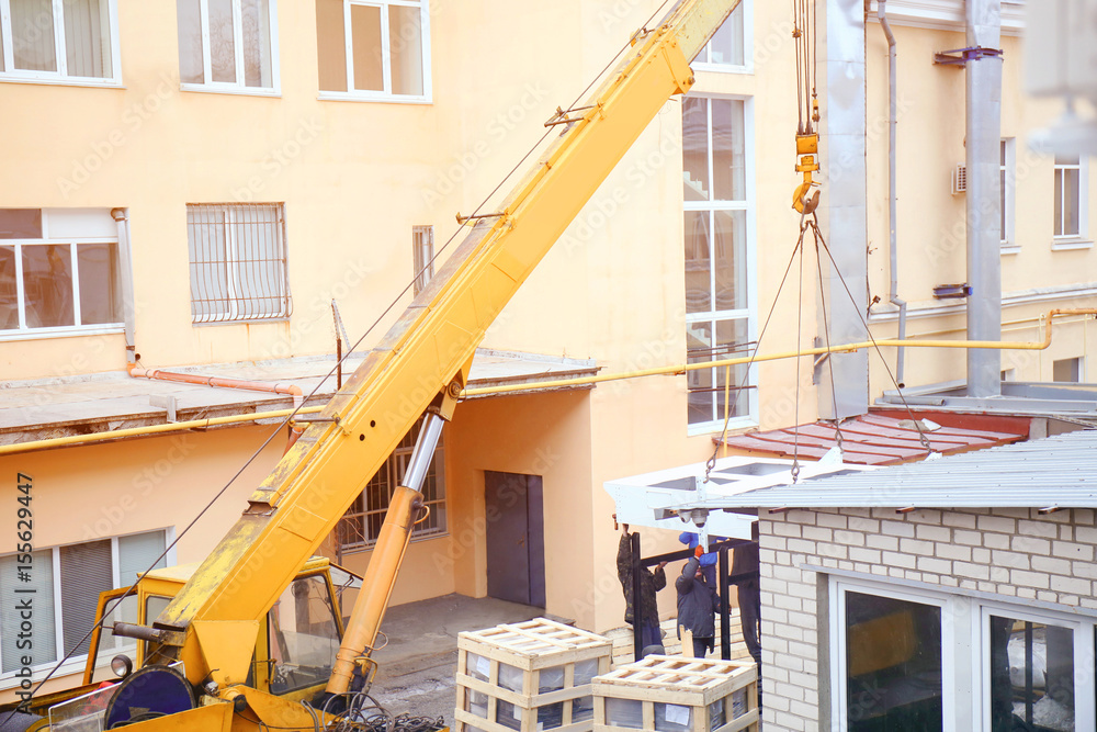 Industrial crane operating and lifting heavy object Stock Photo | Adobe ...