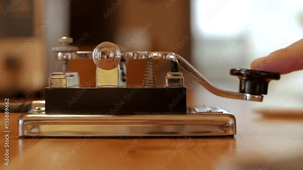 Morse code transmitter being used, communication old style, side angle ...
