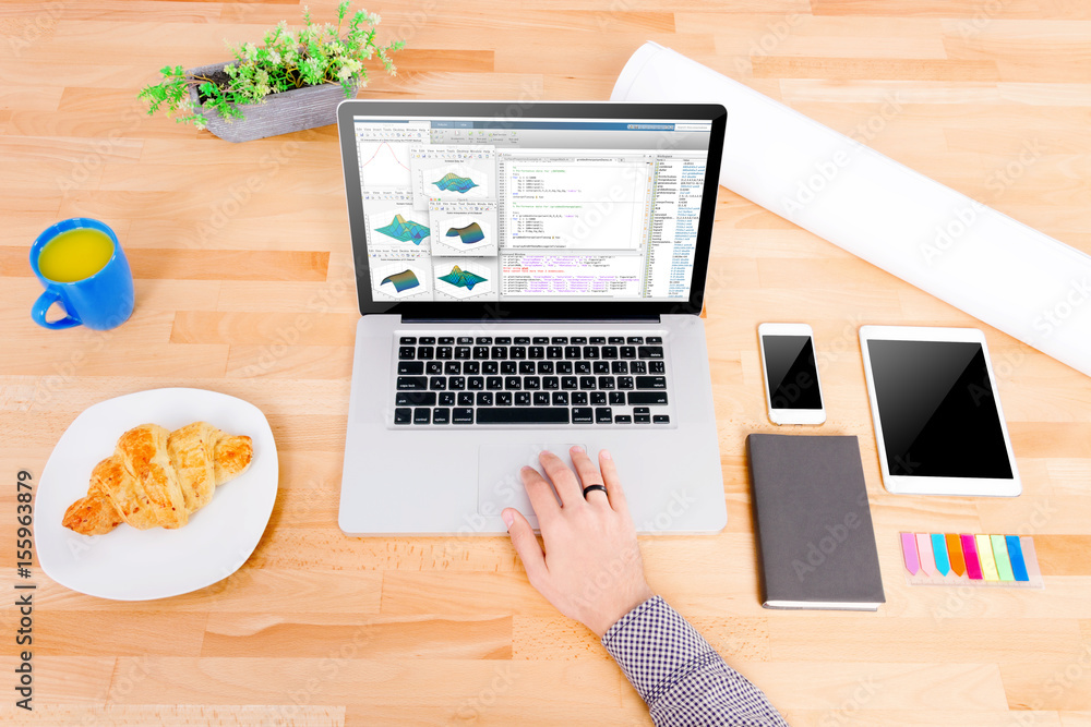 Software / Cad engineer's workplace with laptop with math formulas and ...