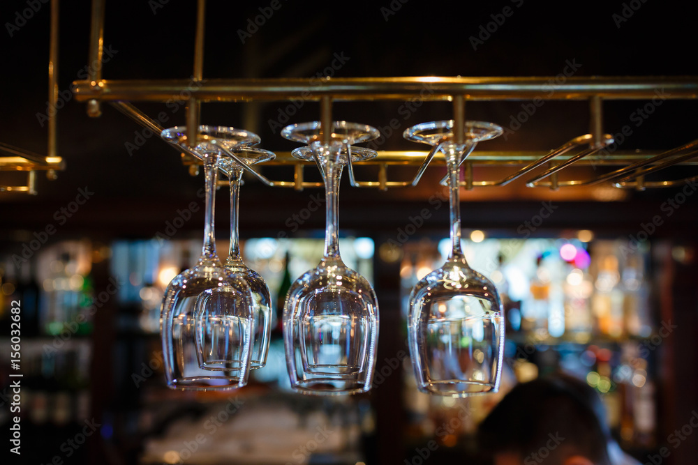 Glasses champagne hangs above the bar counter in the bar. Glasses ...