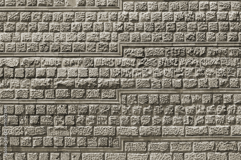 Decorative stone tiles in a wall. Rough dimpled slabs of limestone in ...