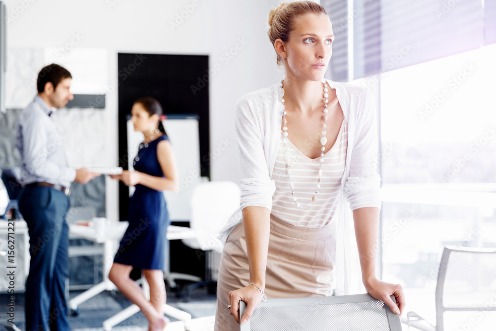 Attractive female worker in office Stock Photo | Adobe Stock