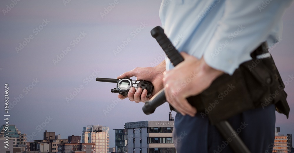 Security guard lower body against buildings and purple sky Stock Photo ...