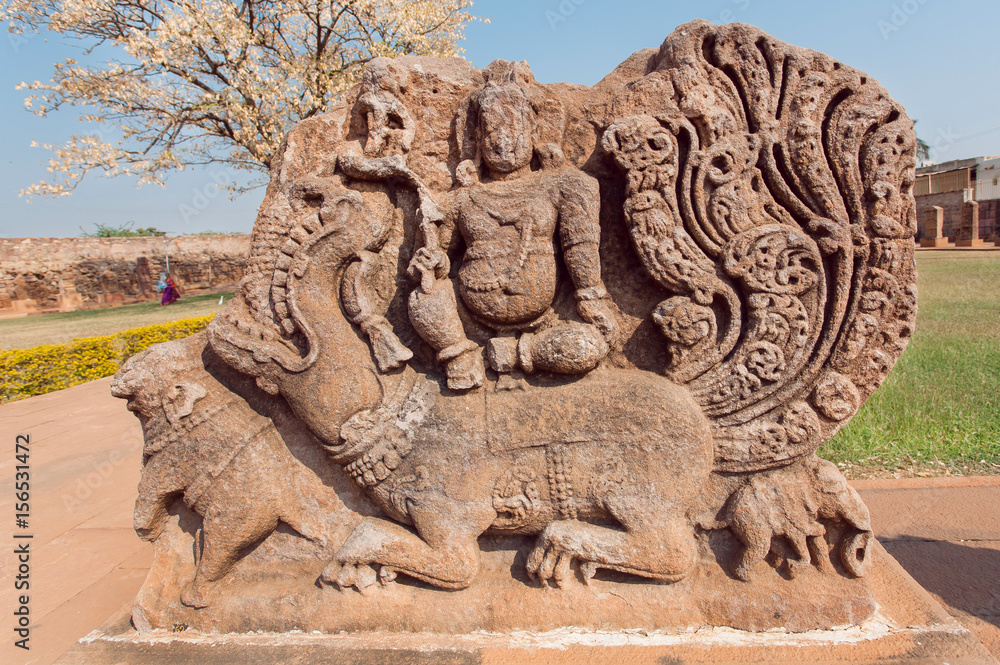 Ancient Hindu god sitting on myth lion creature, ruins of stone relief ...