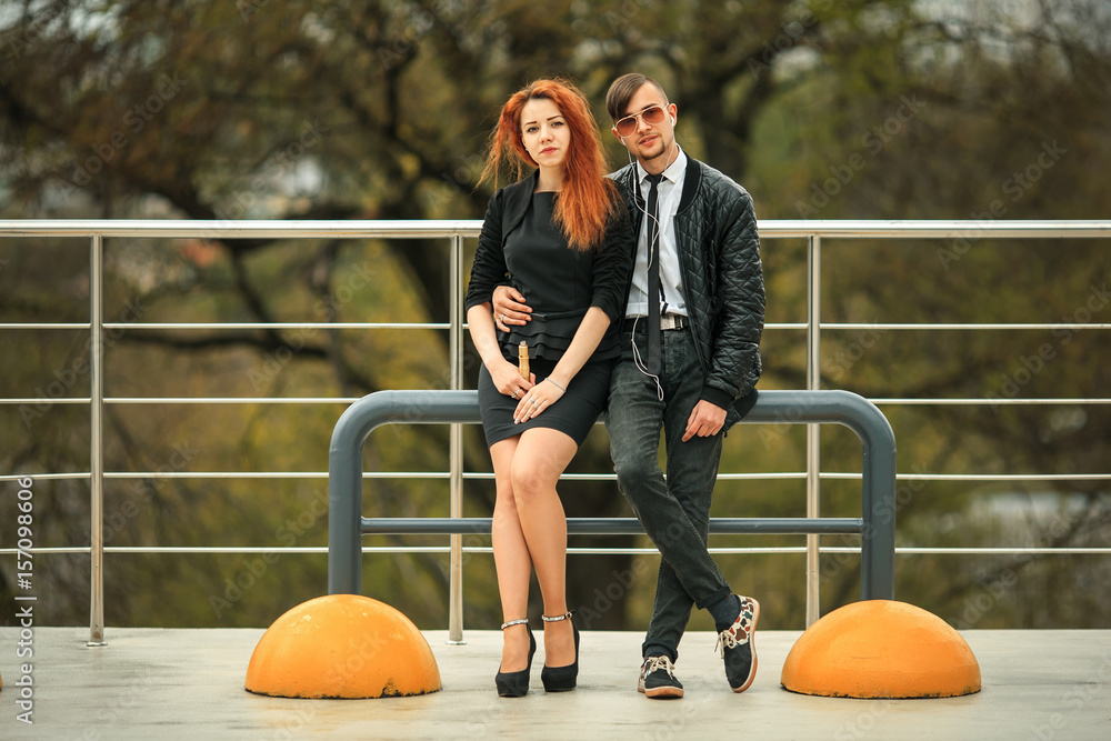 Couple in love. Modern haircuts. Handsome guy in headphones and pretty ...
