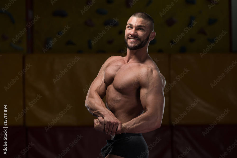 Muscular Bodybuilder Showing His Side Chest Stock Photo | Adobe Stock