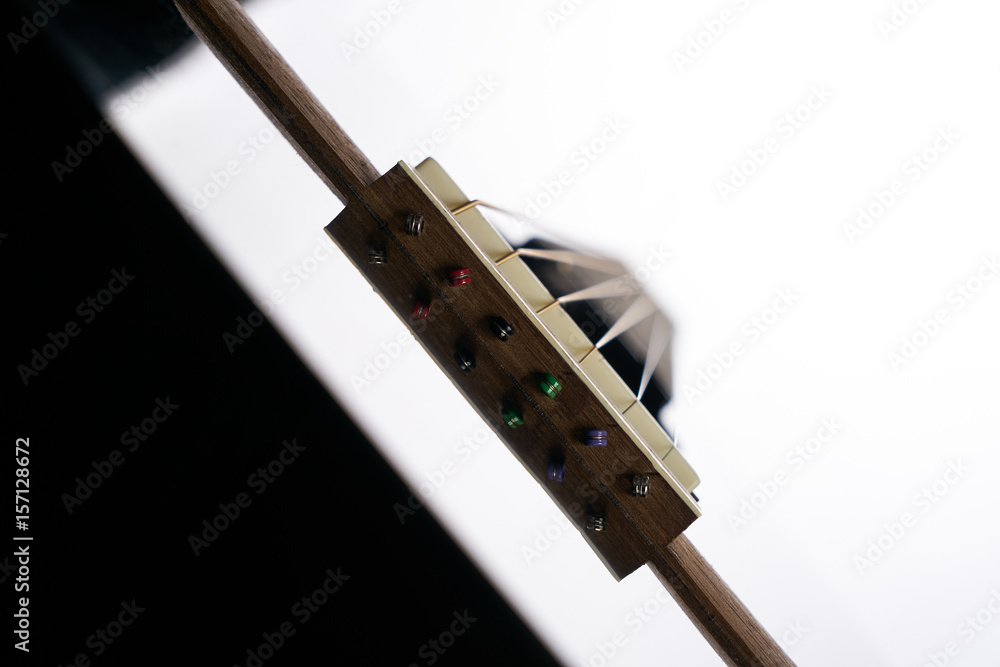 Part of a black Six-string classical acoustic guitar on black ...