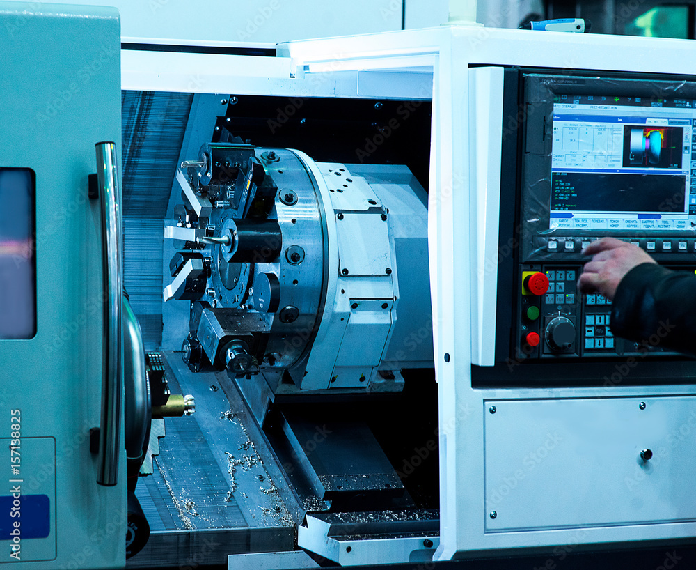 Operator machining automotive part by turning machine, Industry machine ...