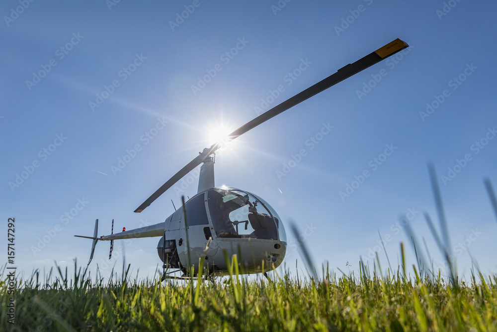 Small Robinson R22 light utility helicopter parked on grass airport ...